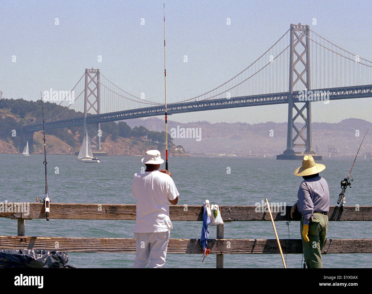 fisherman in front of bay bridge Stock Photo - Alamy