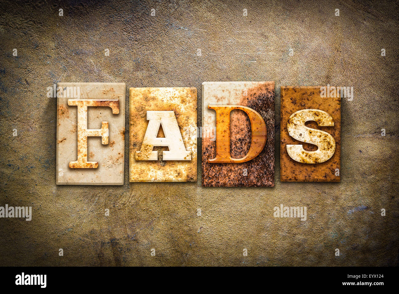 The word "FADS" written in rusty metal letterpress type on an old aged ...