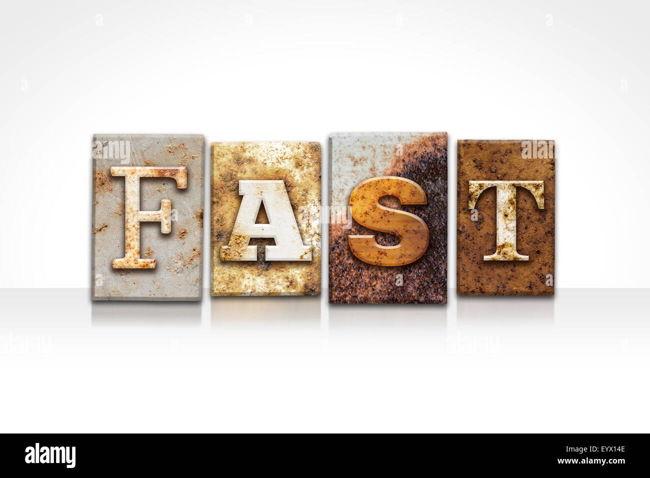 The word "FAST" written in rusty metal letterpress type isolated on a ...