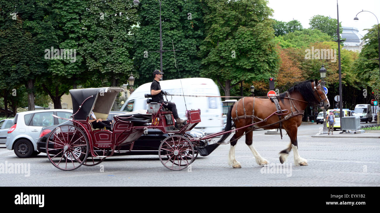 A horse and carriage ride along the Champs Elysees in Paris Stock Photo ...