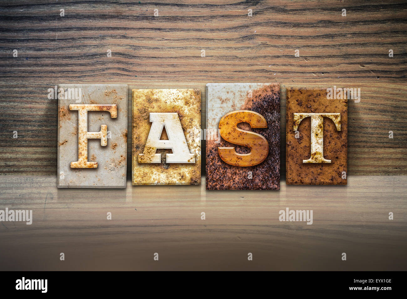 The word "FAST" written in rusty metal letterpress type sitting on a ...