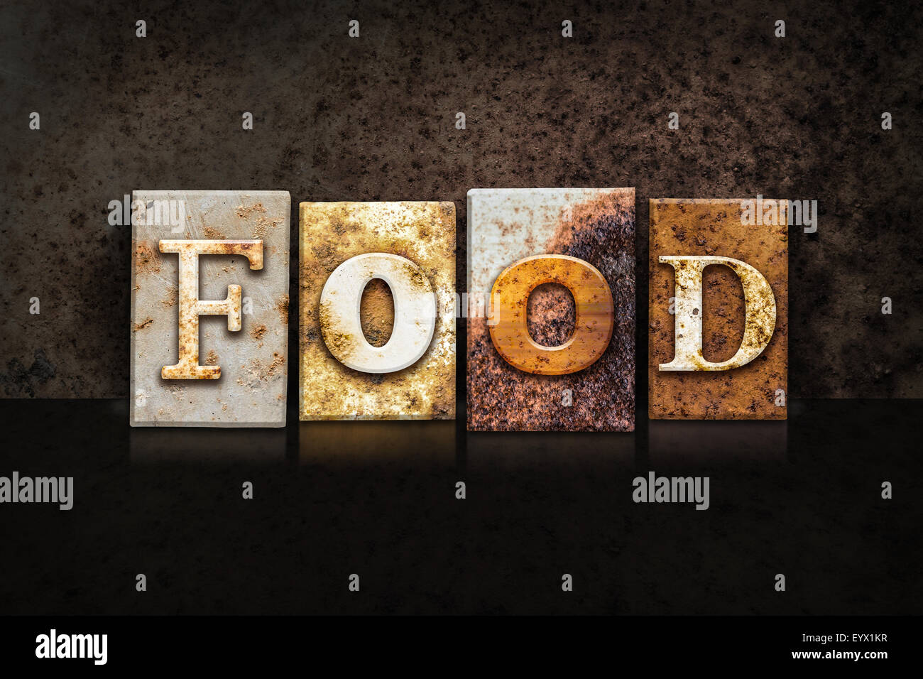 The word "FOOD" written in rusty metal letterpress type on a dark ...