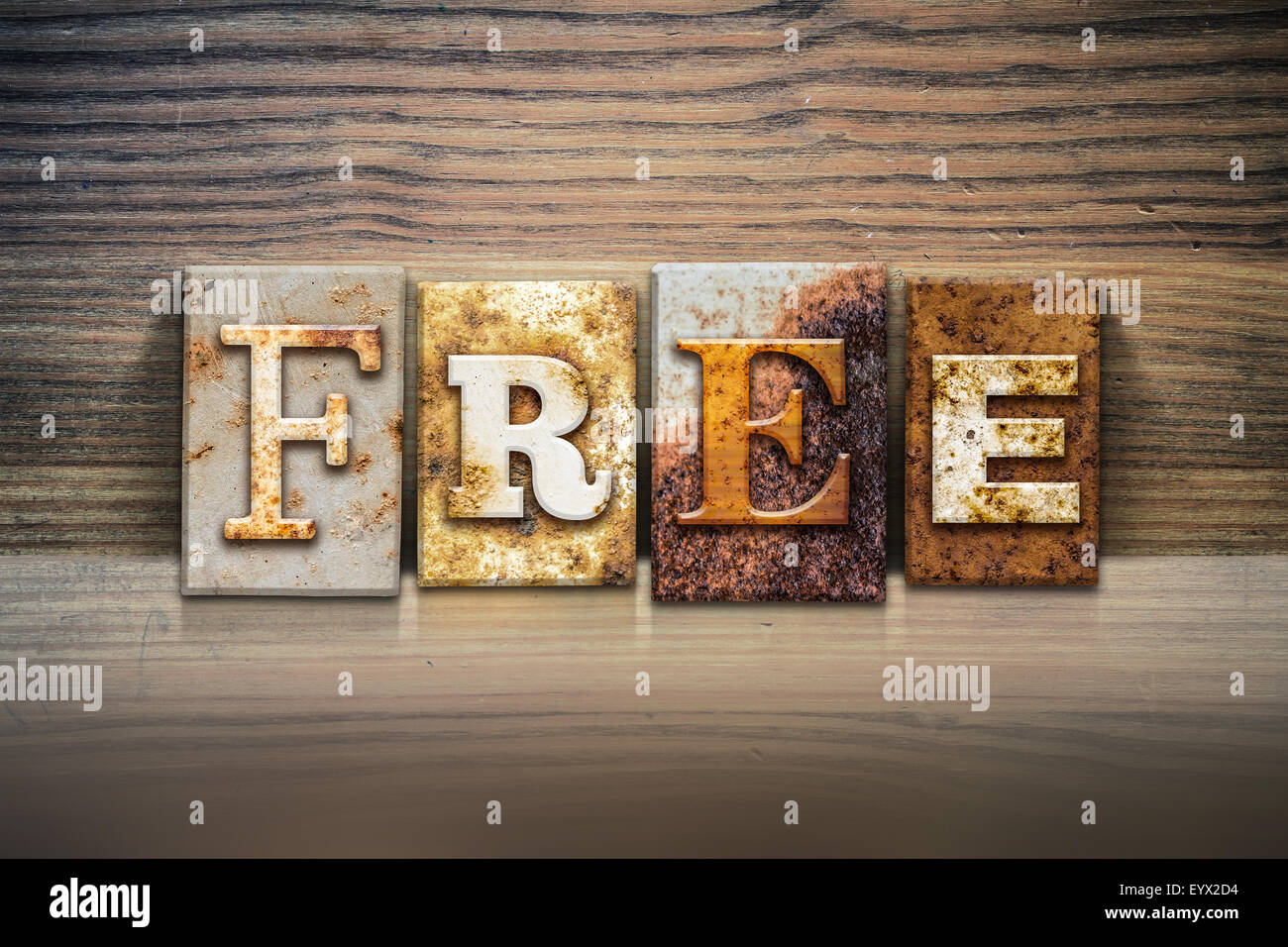 The word "FREE" written in rusty metal letterpress type sitting on a ...
