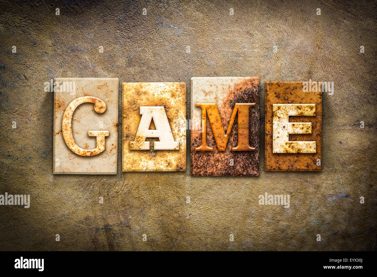 The word "GAME" written in rusty metal letterpress type on an old aged ...