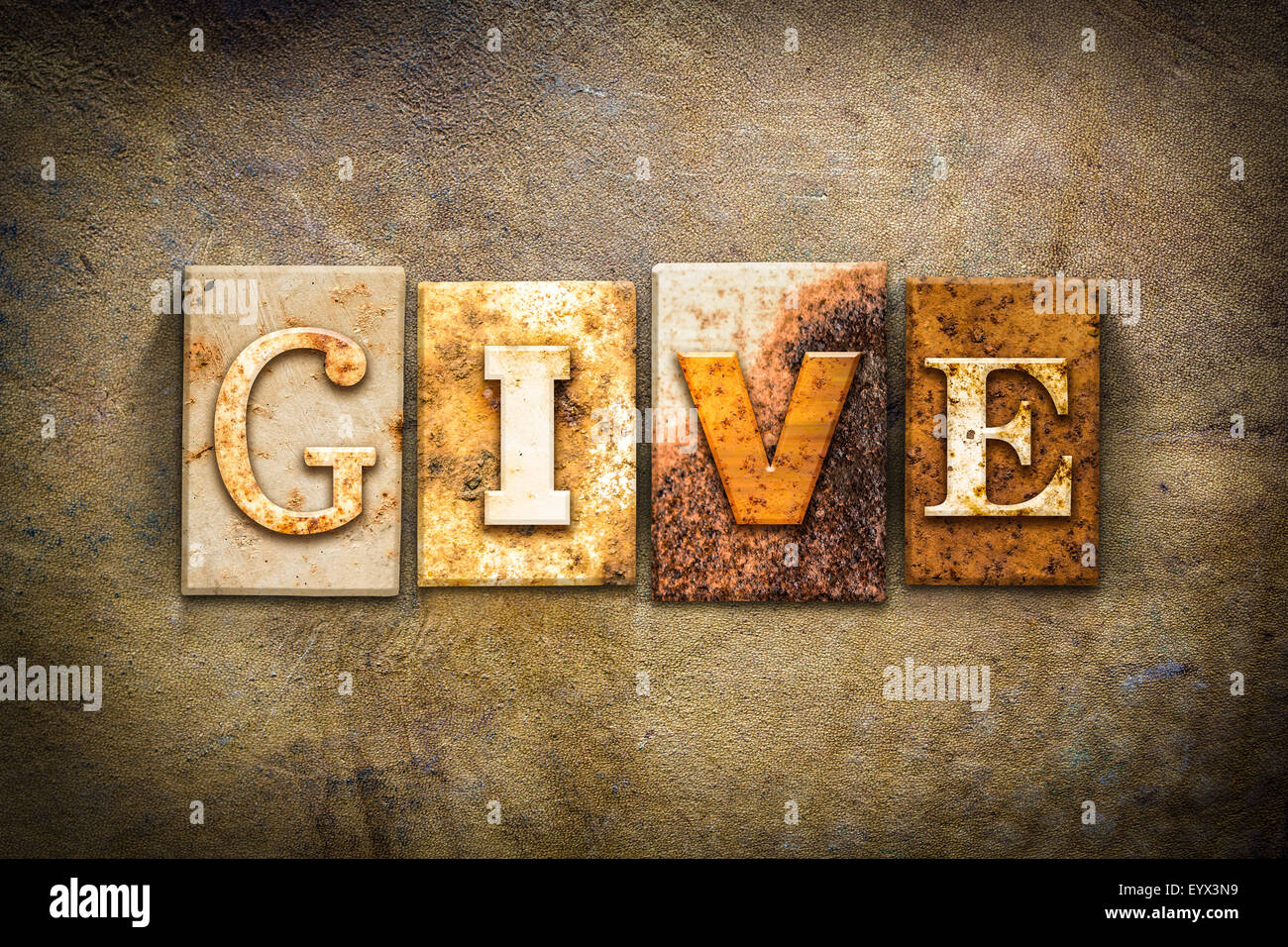 The word "GIVE" written in rusty metal letterpress type on an old aged ...