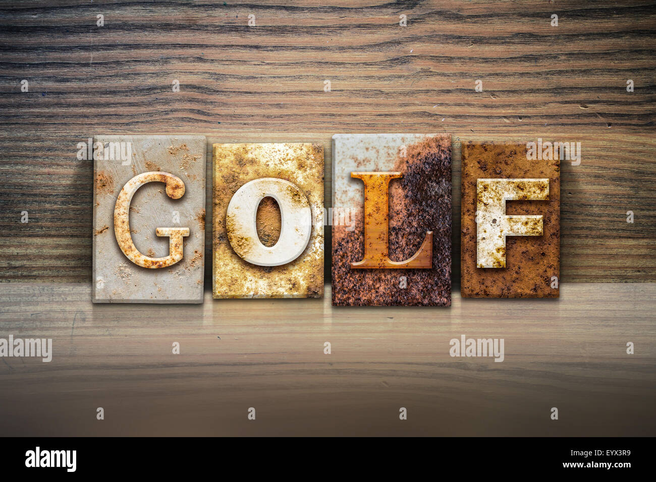 The word "GOLF" written in rusty metal letterpress type sitting on a ...