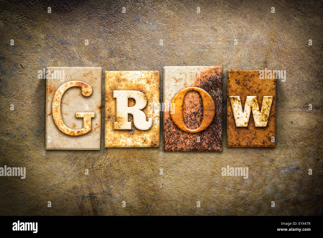 The word "GROW" written in rusty metal letterpress type on an old aged ...