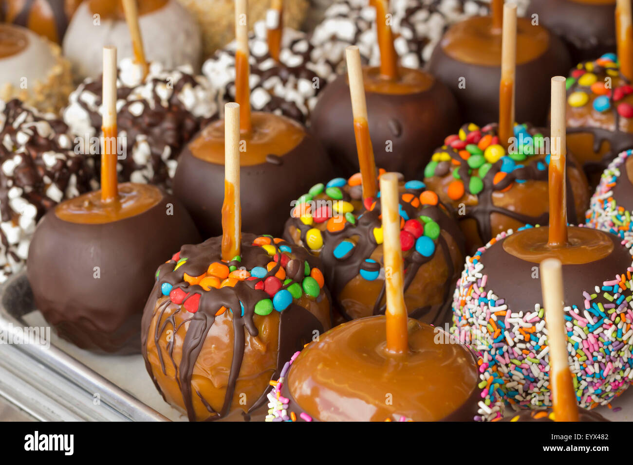 Tray of assorted variety of candy apples at state fair Stock Photo - Alamy