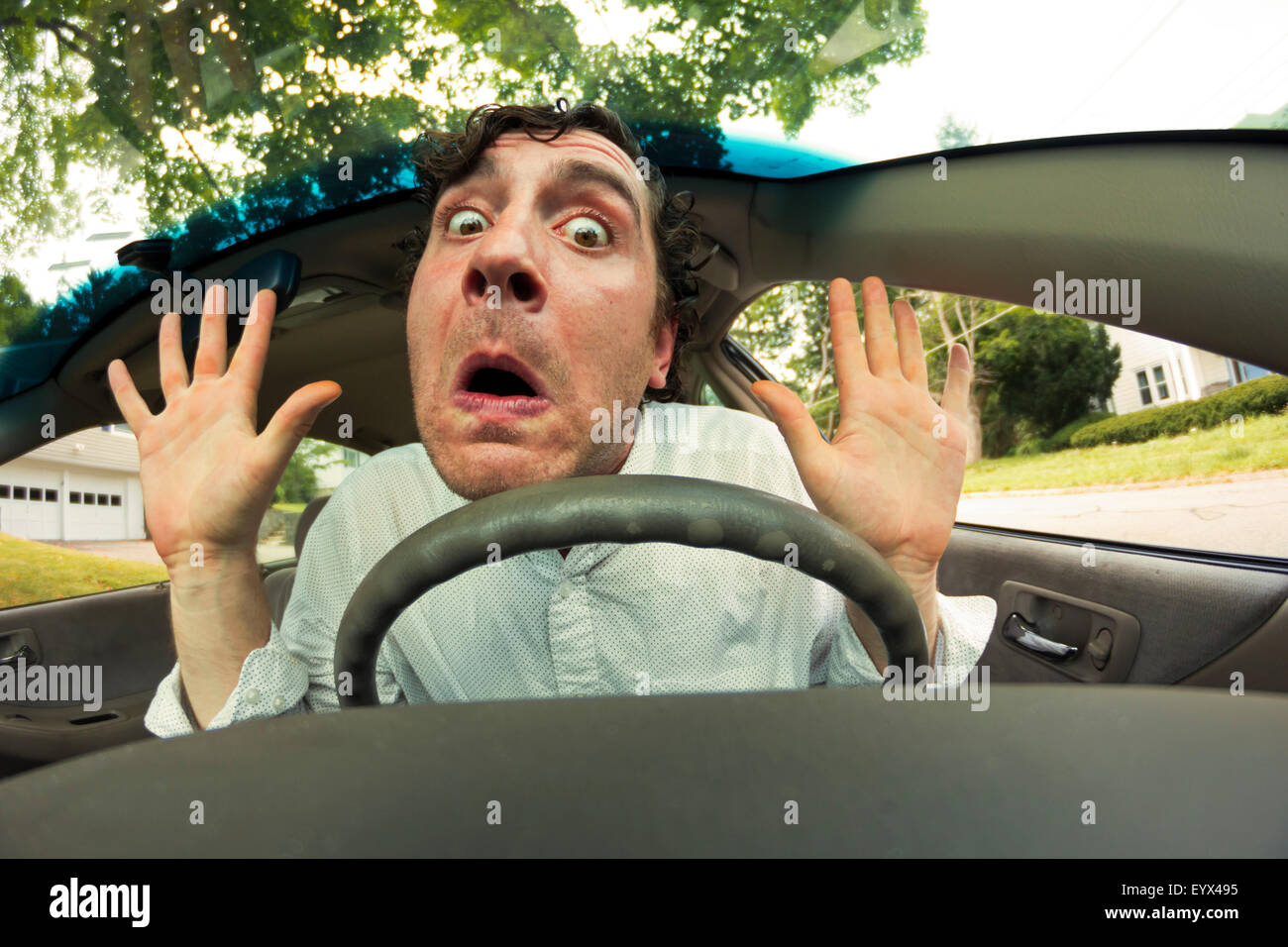 Silly man gets into car crash and makes ridiculous face Stock Photo - Alamy