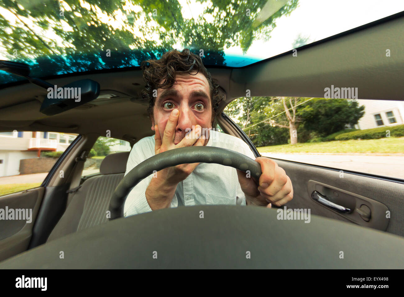 Silly man gets into car crash and makes ridiculous face Stock Photo - Alamy
