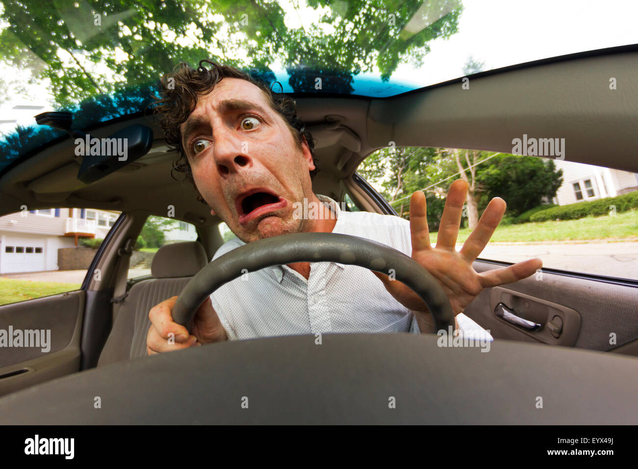 Silly man gets into car crash and makes ridiculous face Stock Photo - Alamy
