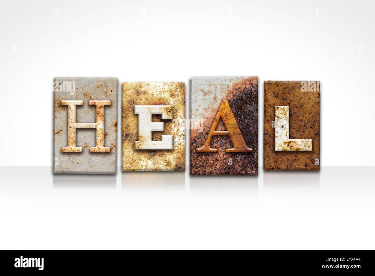 The word "HEAL" written in rusty metal letterpress type isolated on a ...