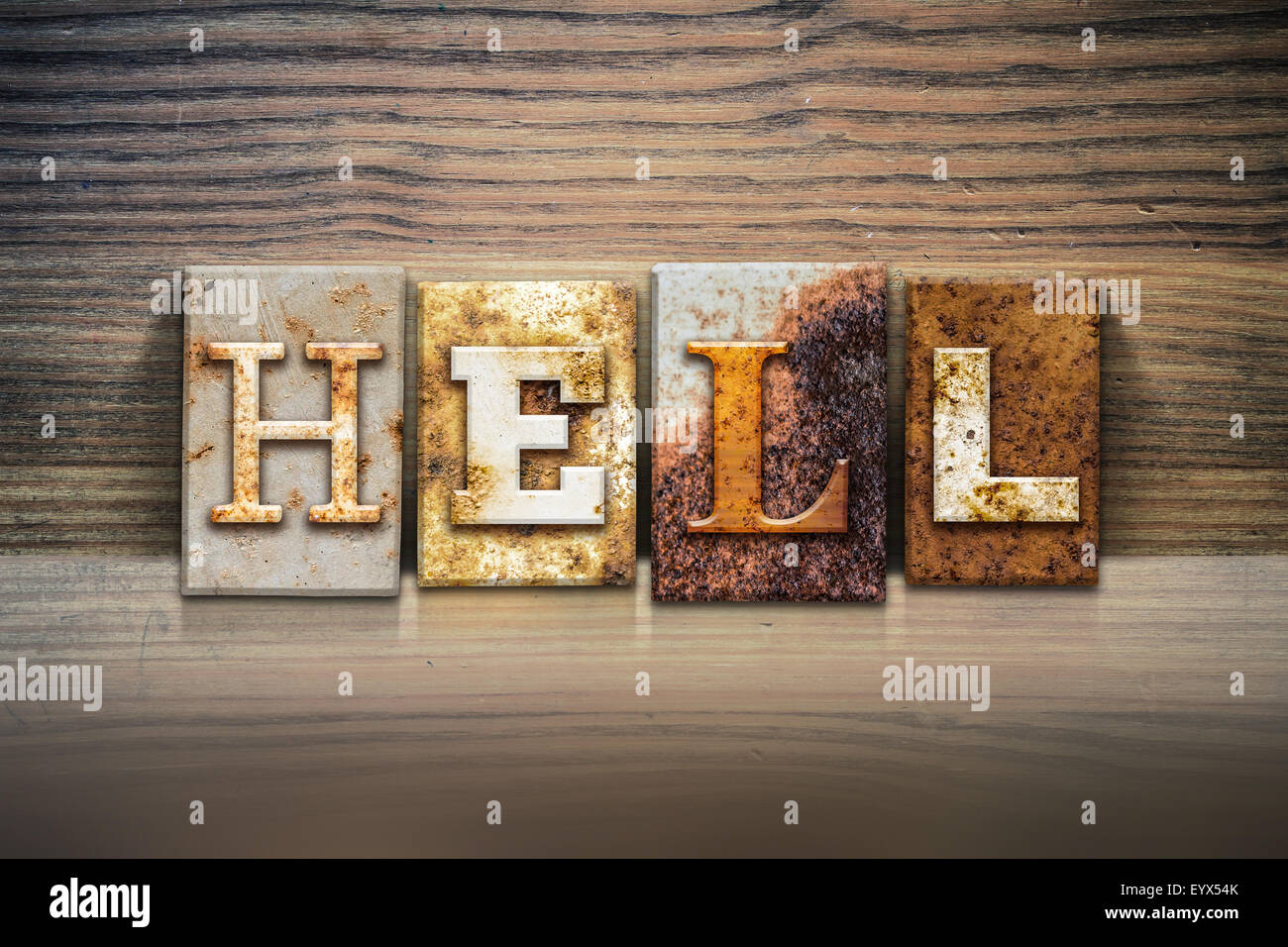 The word "HELL" written in rusty metal letterpress type sitting on a ...