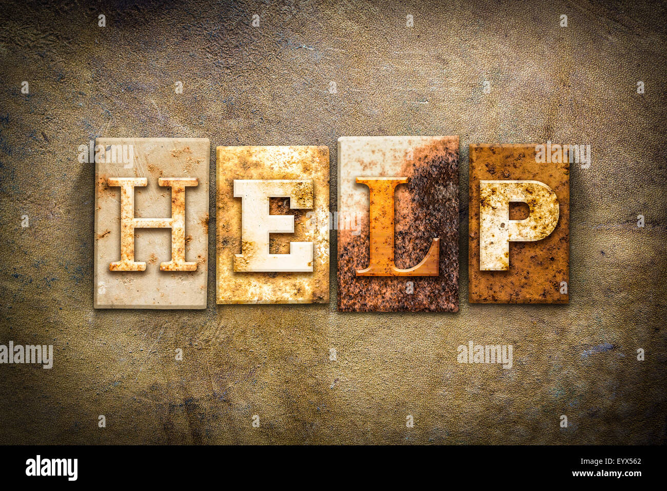 The word "HELP" written in rusty metal letterpress type on an old aged ...