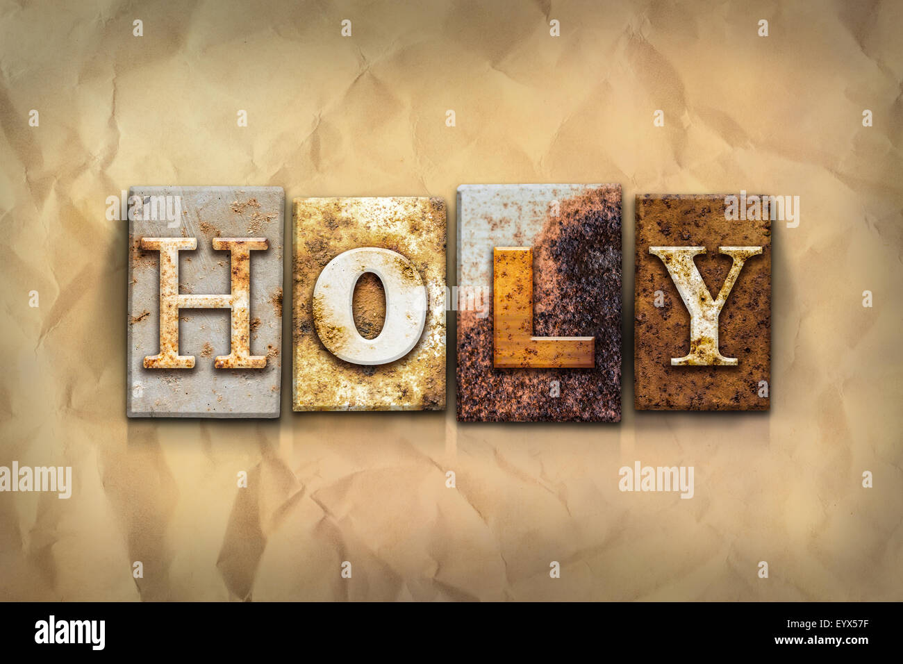 The word "HOLY" written in rusty metal letterpress type on a crumbled ...