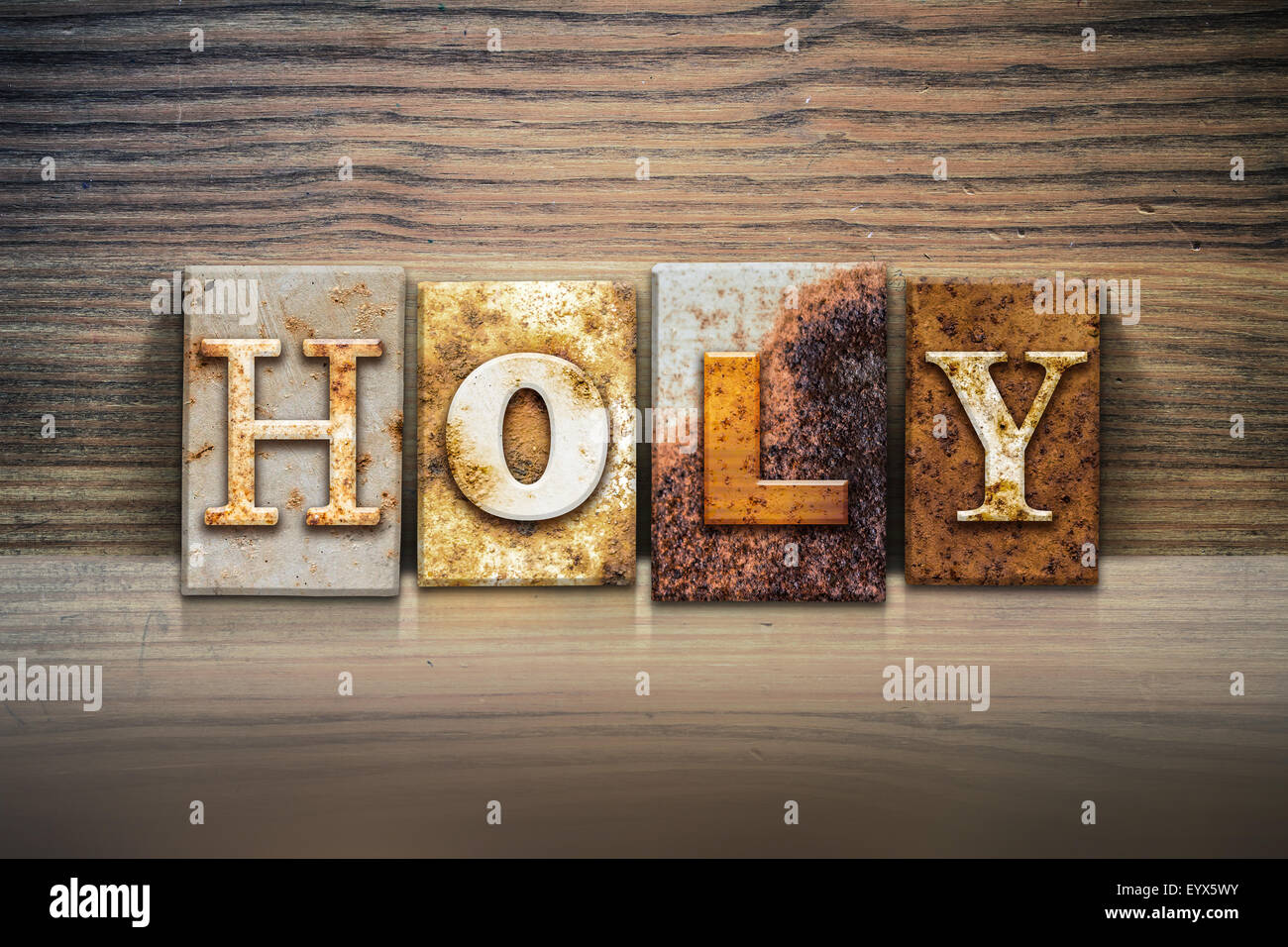 The word "HOLY" written in rusty metal letterpress type sitting on a ...