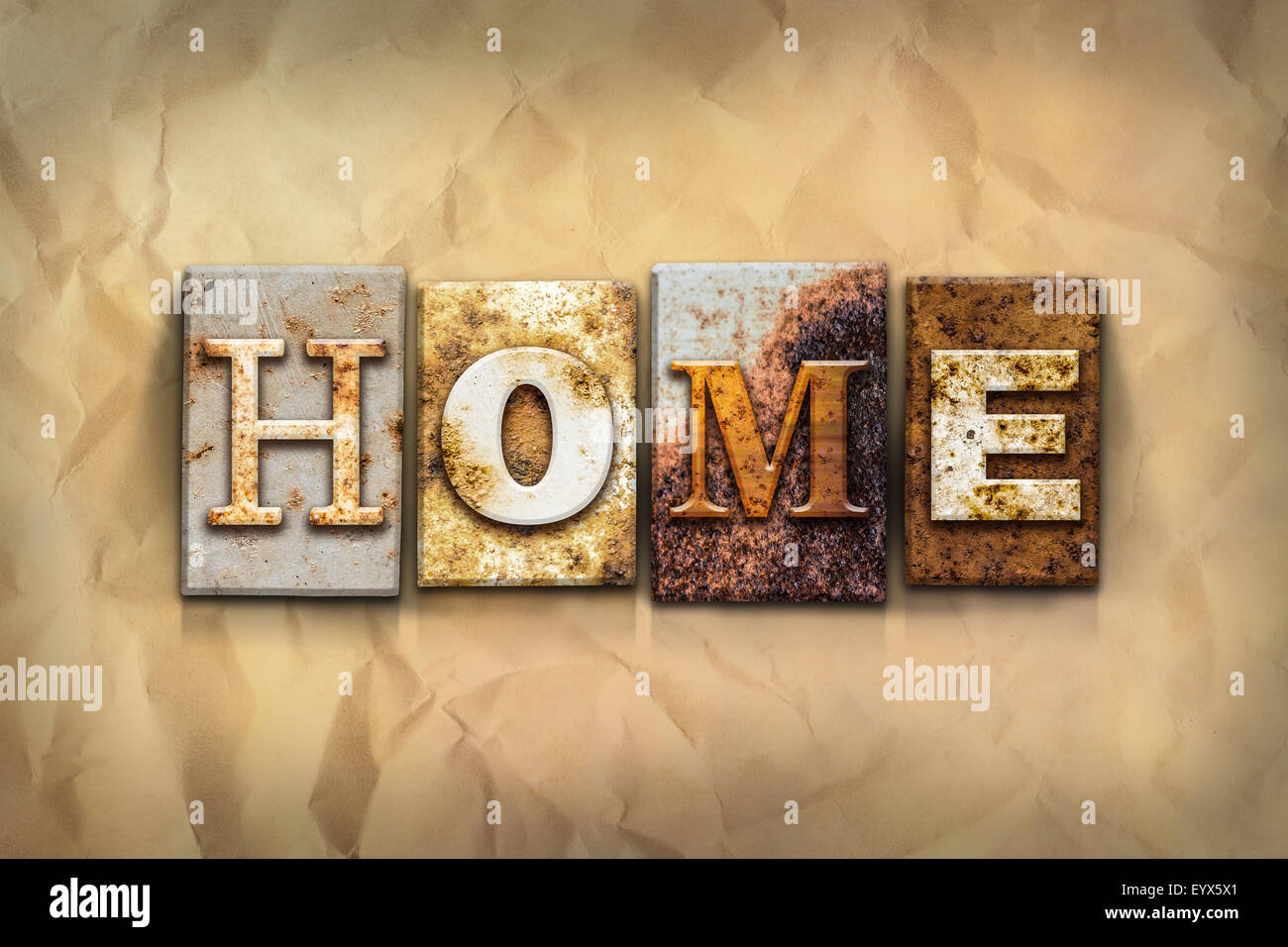 The word "HOME" written in rusty metal letterpress type on a crumbled ...