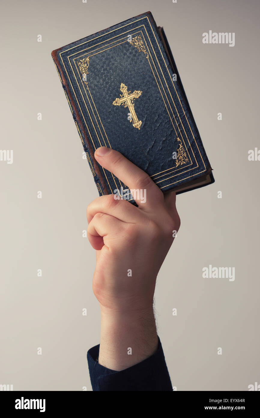 Man holding up bible hi-res stock photography and images - Alamy