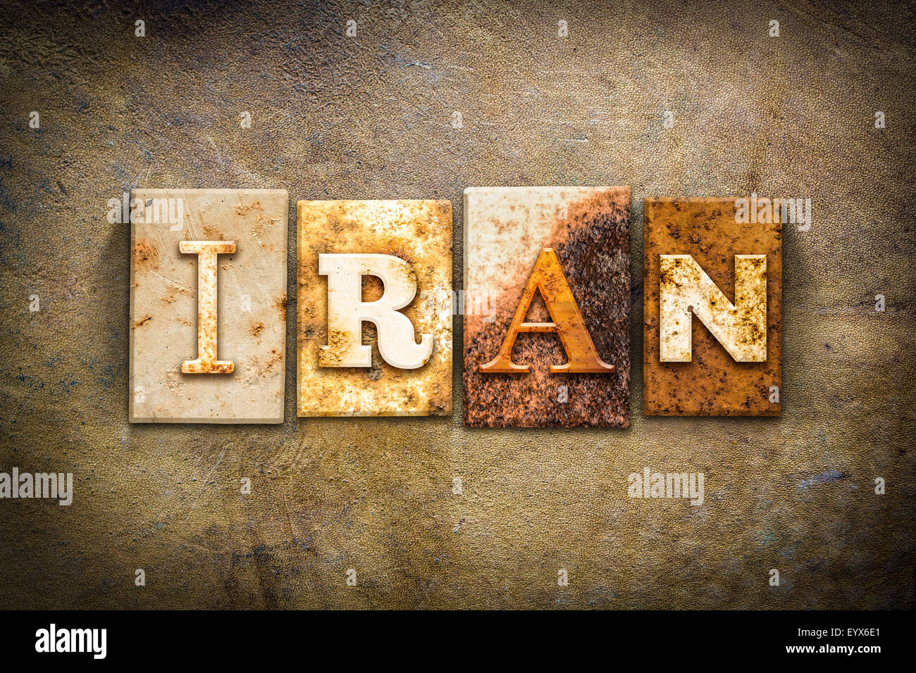 The word "IRAN" written in rusty metal letterpress type on an old aged ...