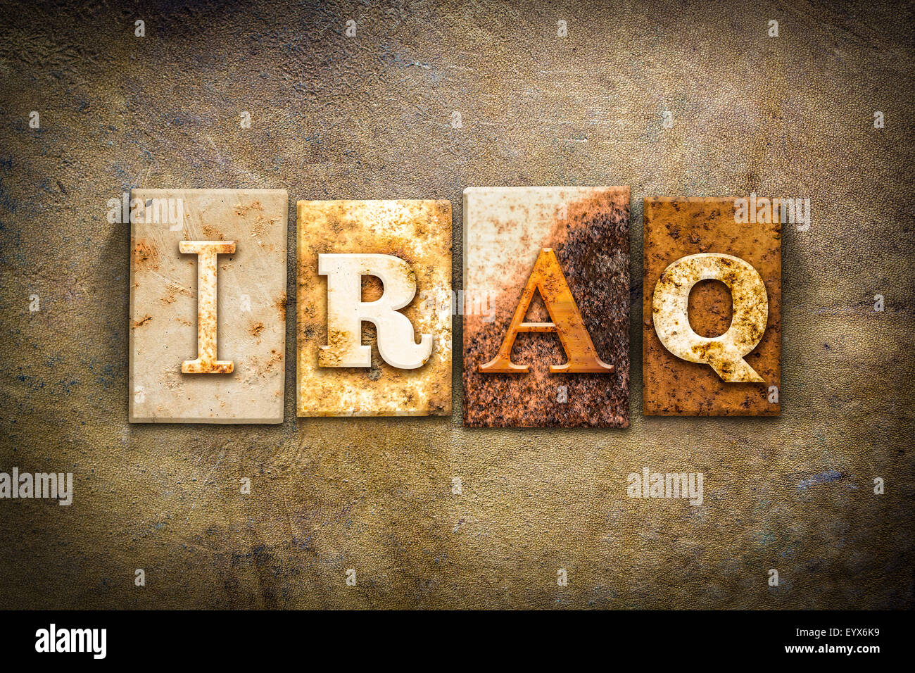 The word "IRAQ" written in rusty metal letterpress type on an old aged ...