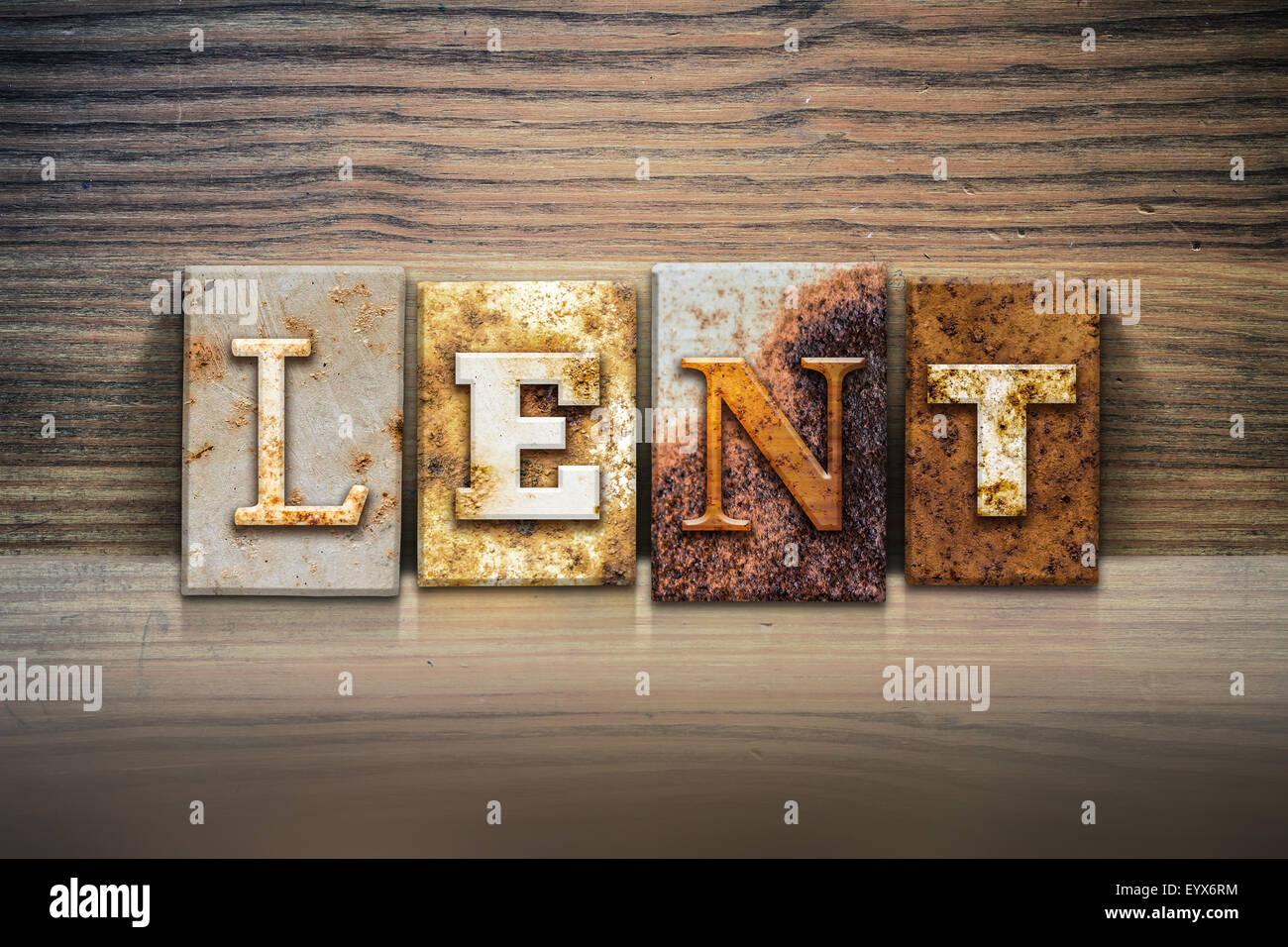 The word "LENT" written in rusty metal letterpress type sitting on a ...
