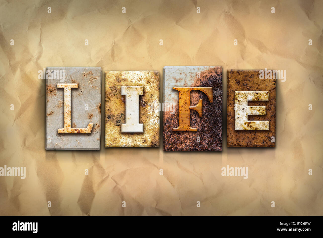 The word "LIFE" written in rusty metal letterpress type on a crumbled ...