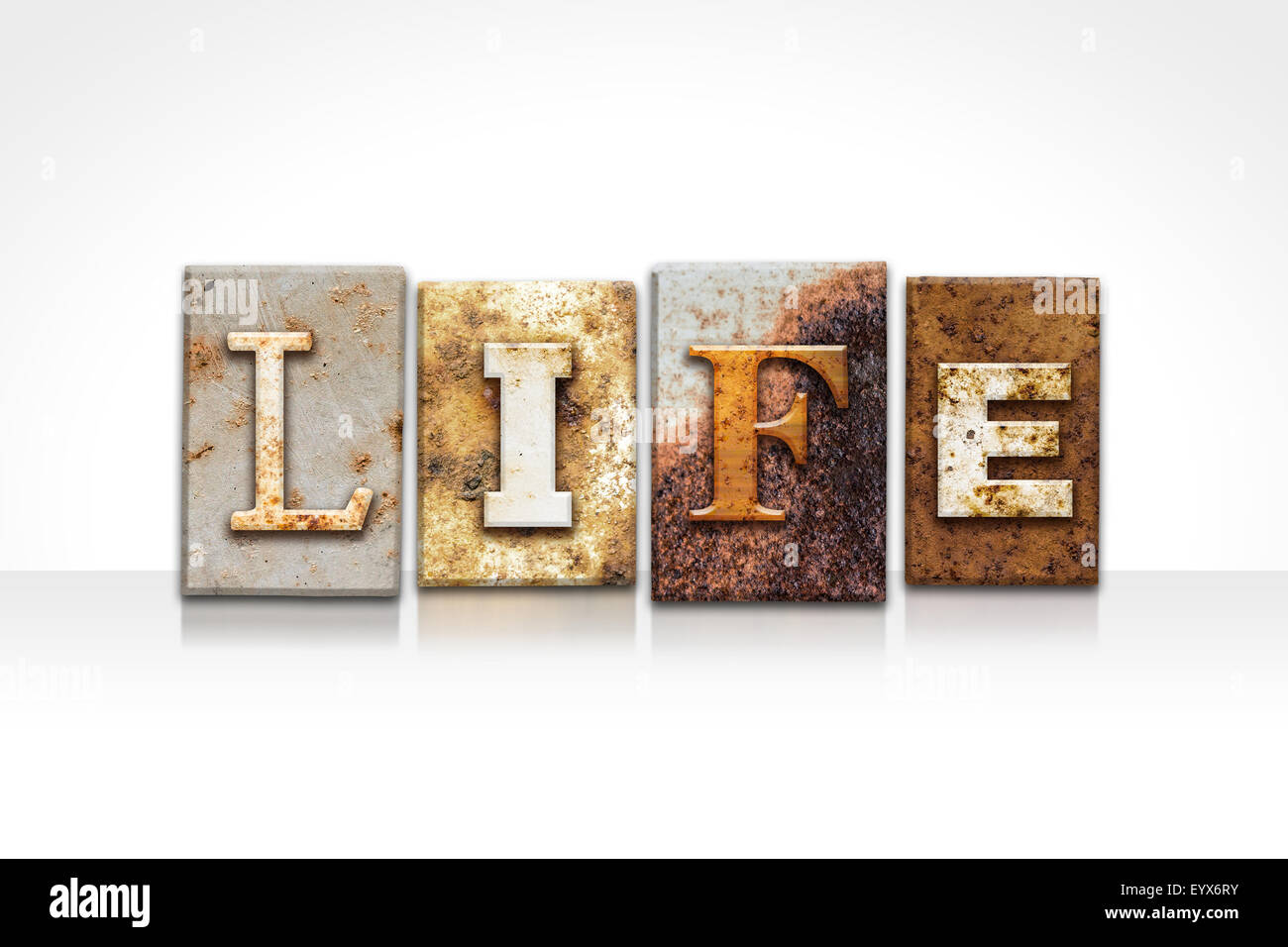 The word "LIFE" written in rusty metal letterpress type isolated on a ...