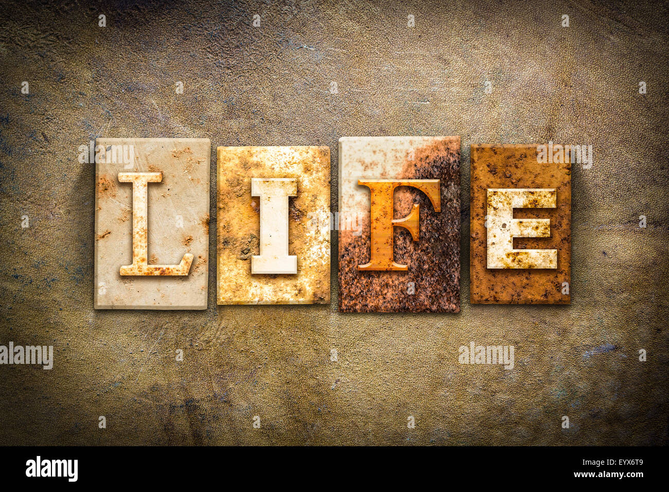 The word "LIFE" written in rusty metal letterpress type on an old aged ...