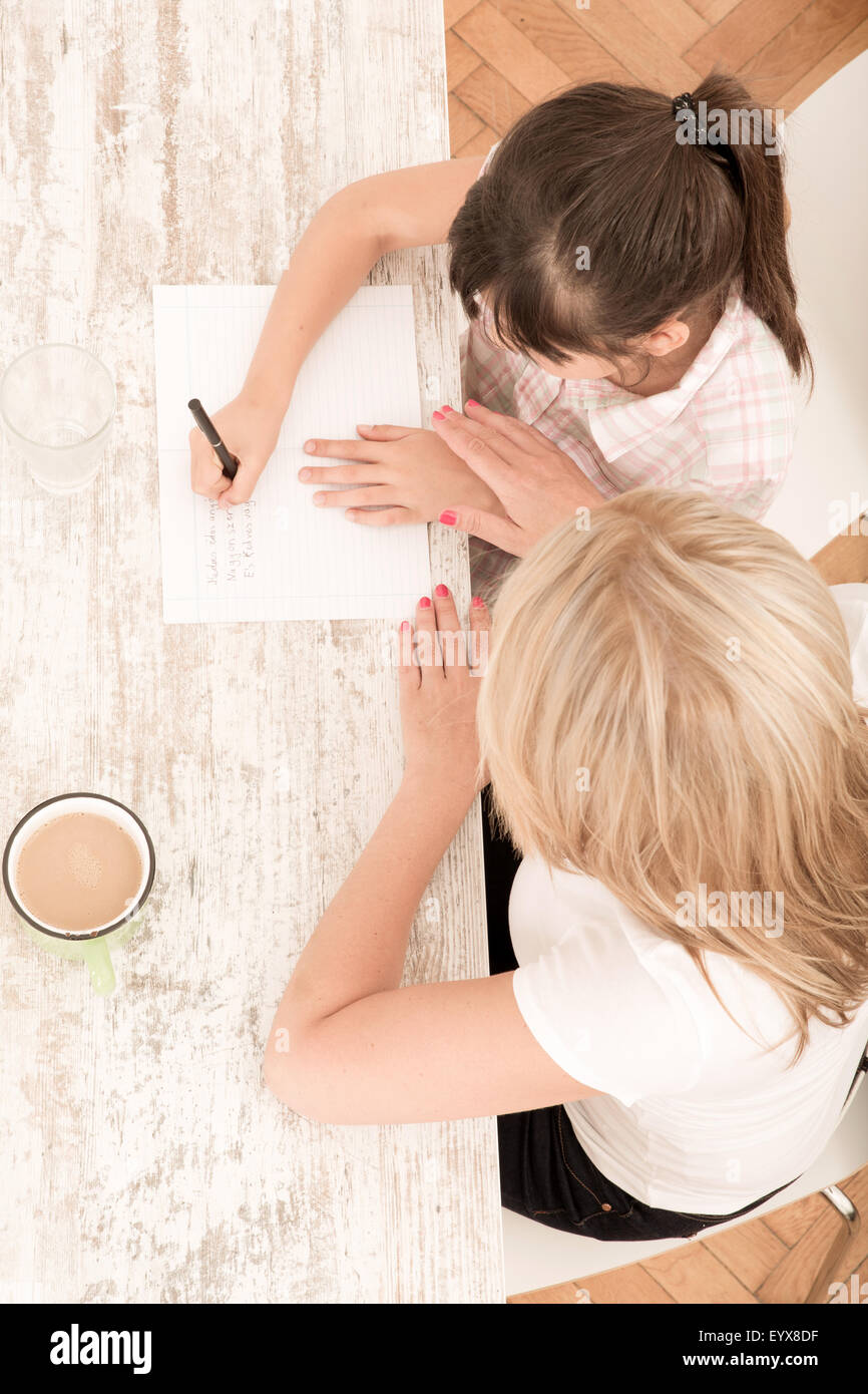 A mother helping her daughter with the homework seen from above Stock ...