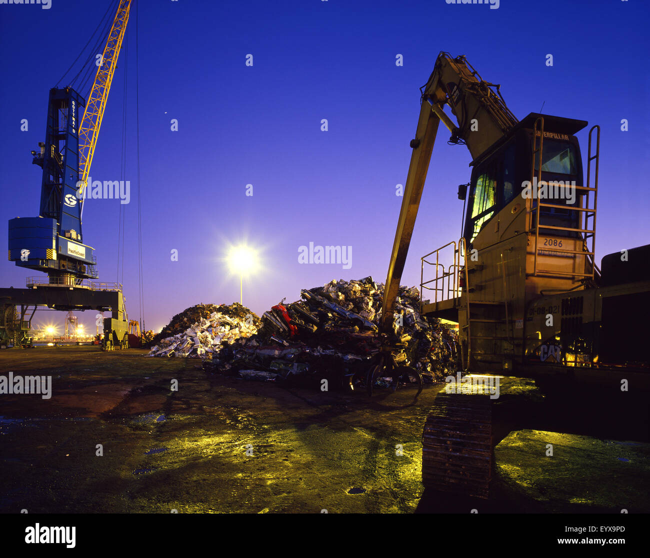 scrap yard at night with cranes Stock Photo - Alamy