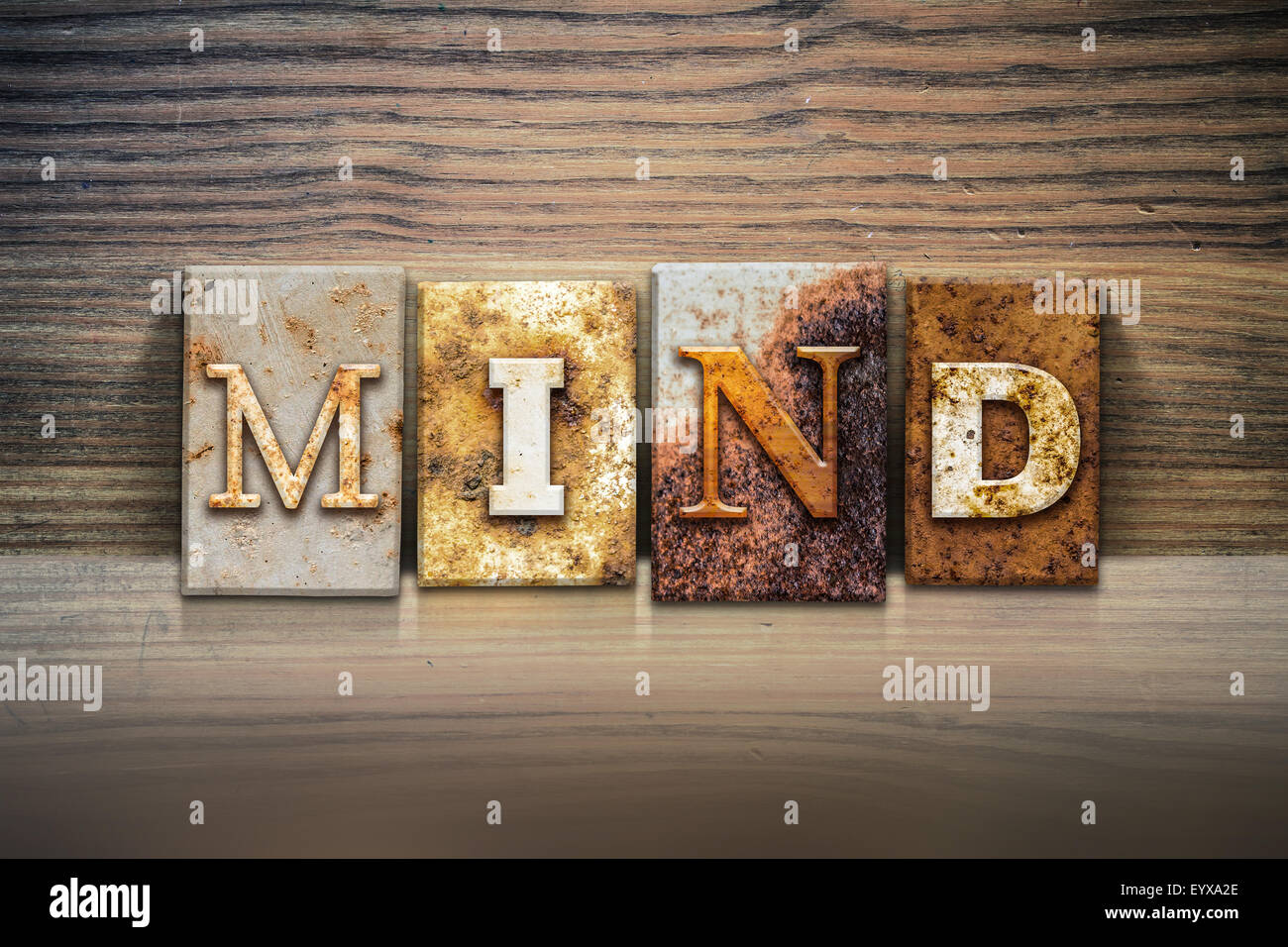 The word "MIND" written in rusty metal letterpress type sitting on a ...