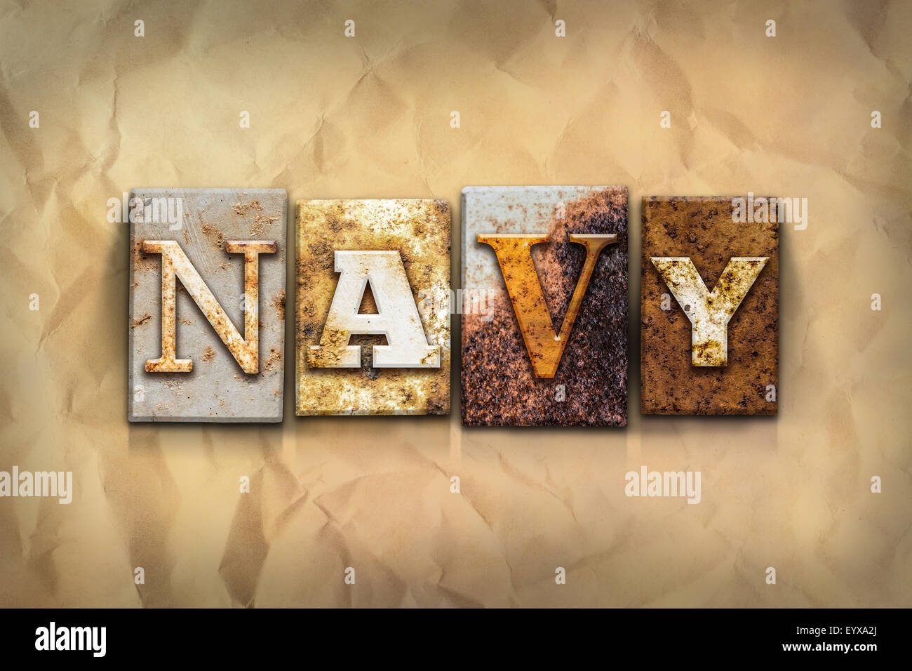 The word "NAVY" written in rusty metal letterpress type on a crumbled ...