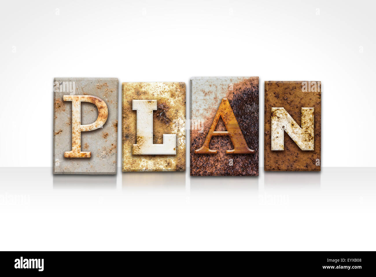 The word "PLAN" written in rusty metal letterpress type isolated on a ...