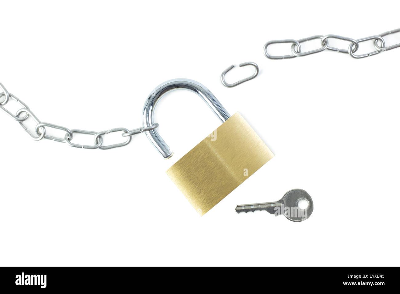 Broken metal chain, unlocked padlock and a key viewed from above ...