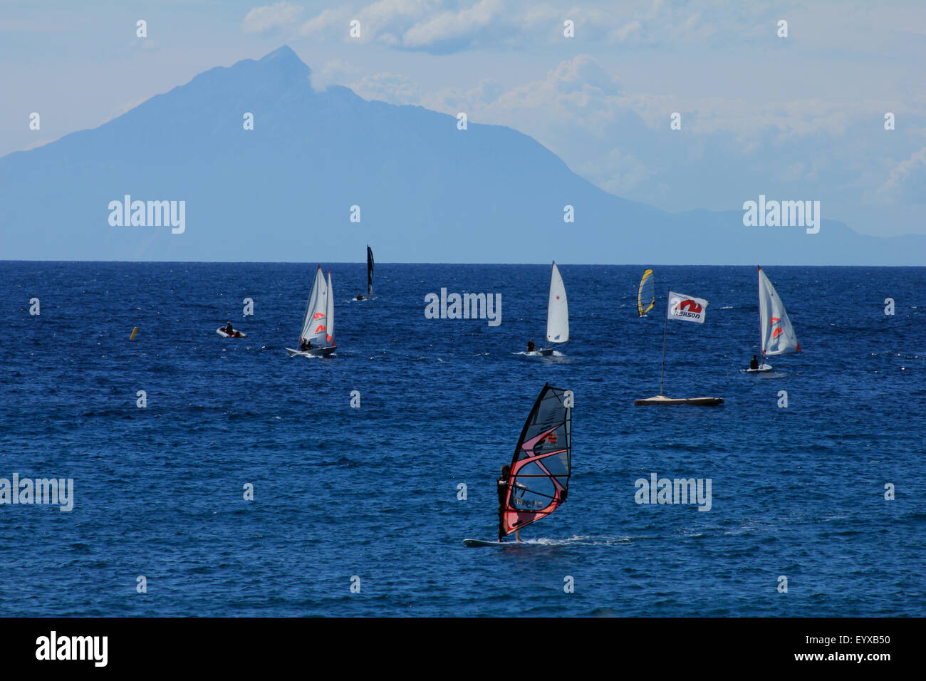 Laser boats and windsurfers sailing in the open sea. Porto Myrina ...