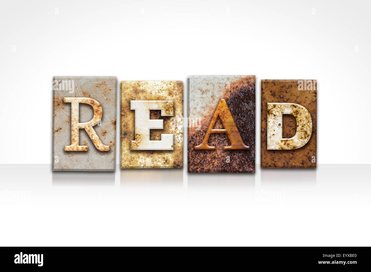 The word "READ" written in rusty metal letterpress type isolated on a ...