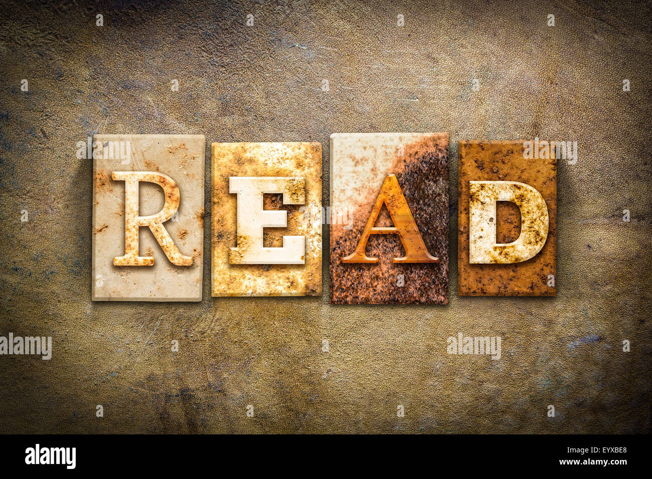 The word "READ" written in rusty metal letterpress type on an old aged ...