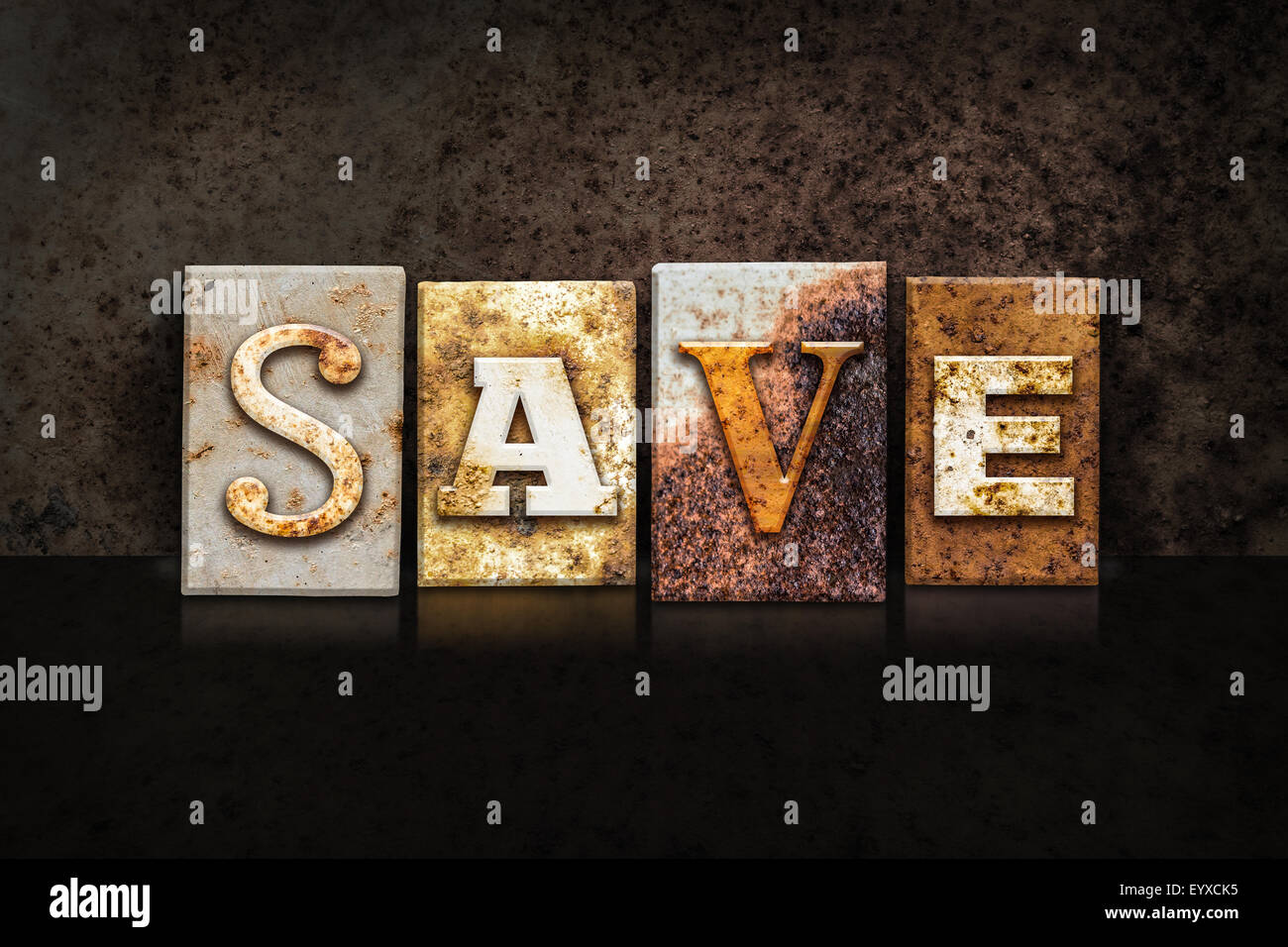 The word "SAVE" written in rusty metal letterpress type on a dark ...