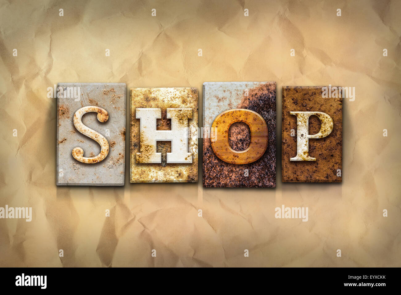 The word "SHOP" written in rusty metal letterpress type on a crumbled ...