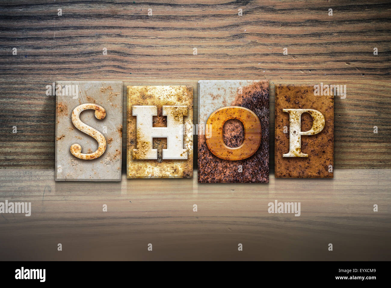 The word "SHOP" written in rusty metal letterpress type sitting on a ...