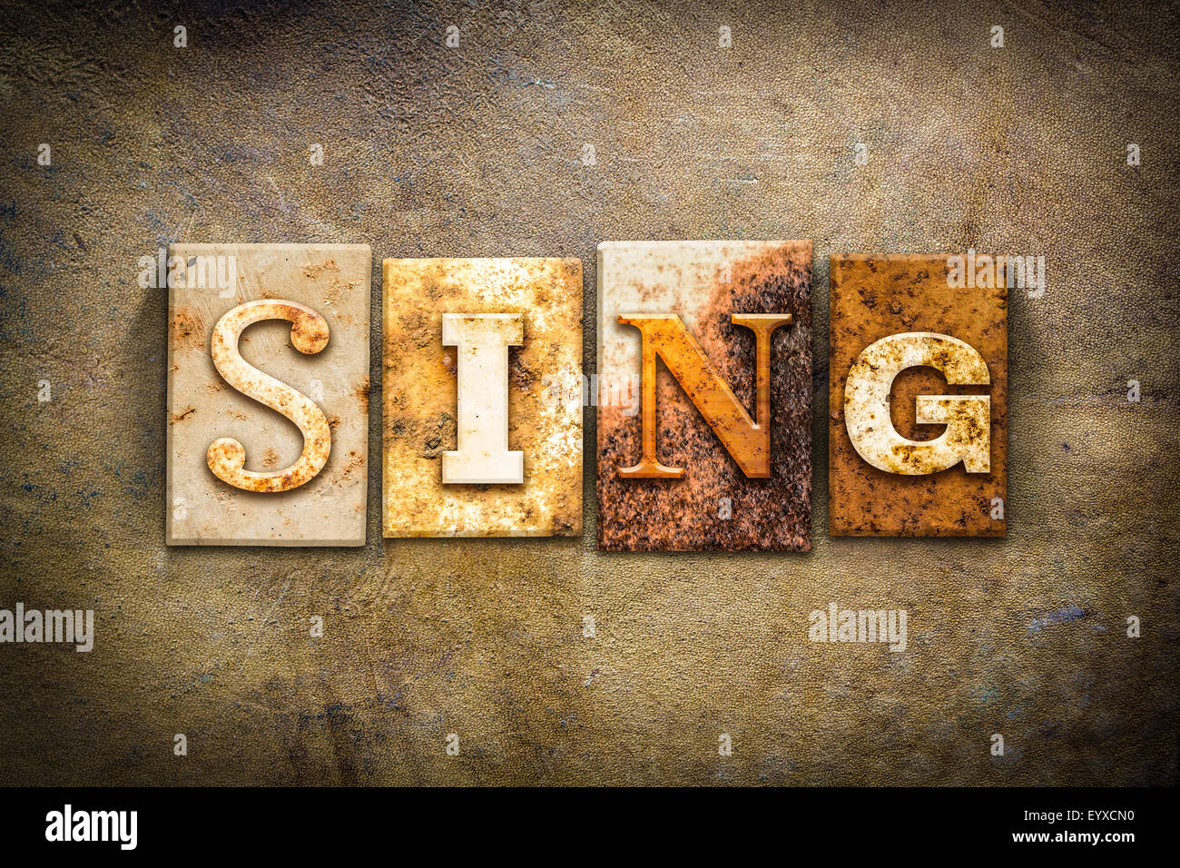 The word "SING" written in rusty metal letterpress type on an old aged ...