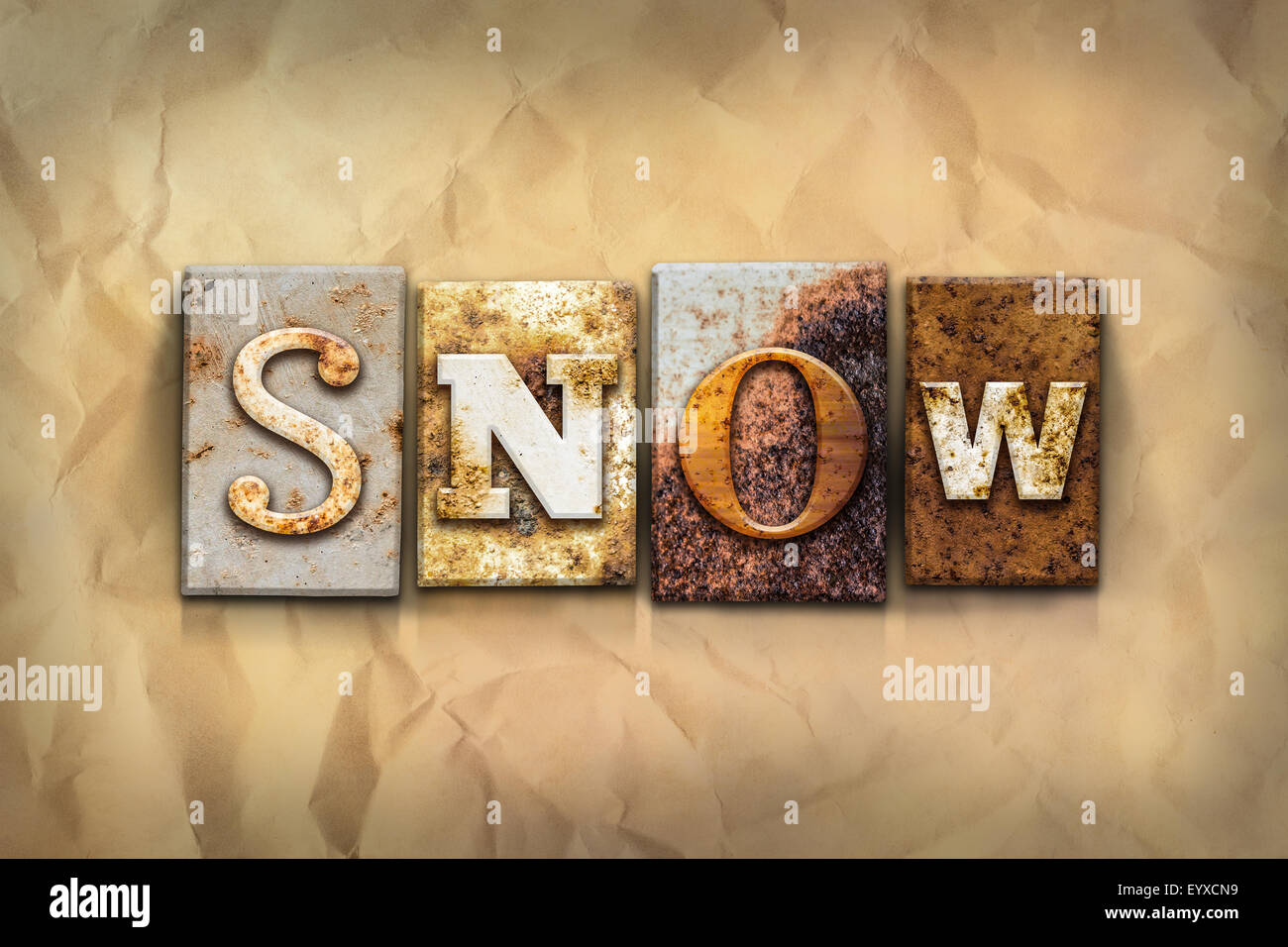 The word "SNOW" written in rusty metal letterpress type on a crumbled ...