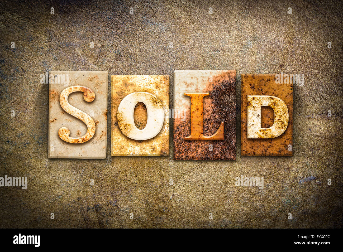 The word "SOLD" written in rusty metal letterpress type on an old aged ...
