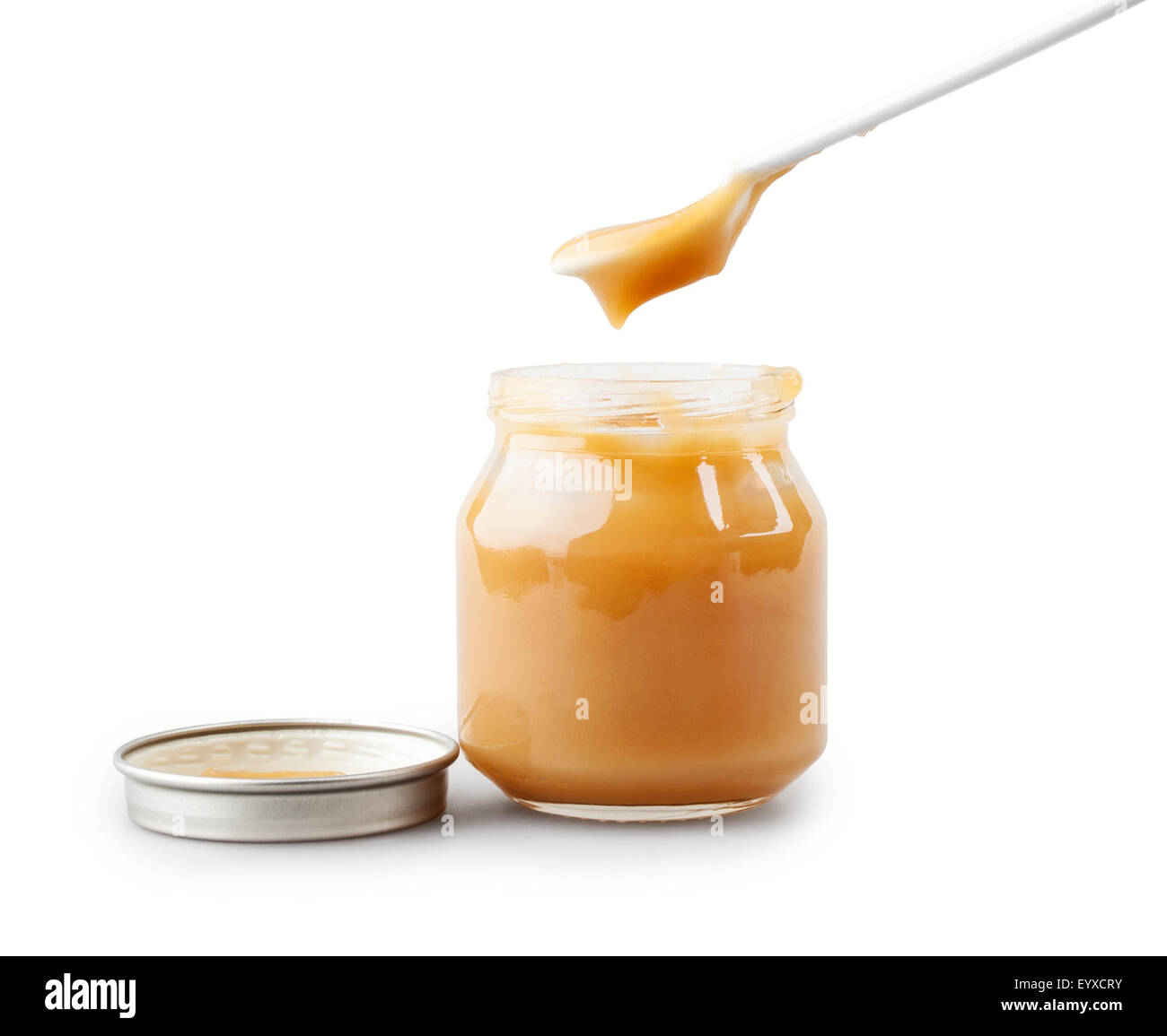 Open baby puree with spoon on white background Stock Photo - Alamy