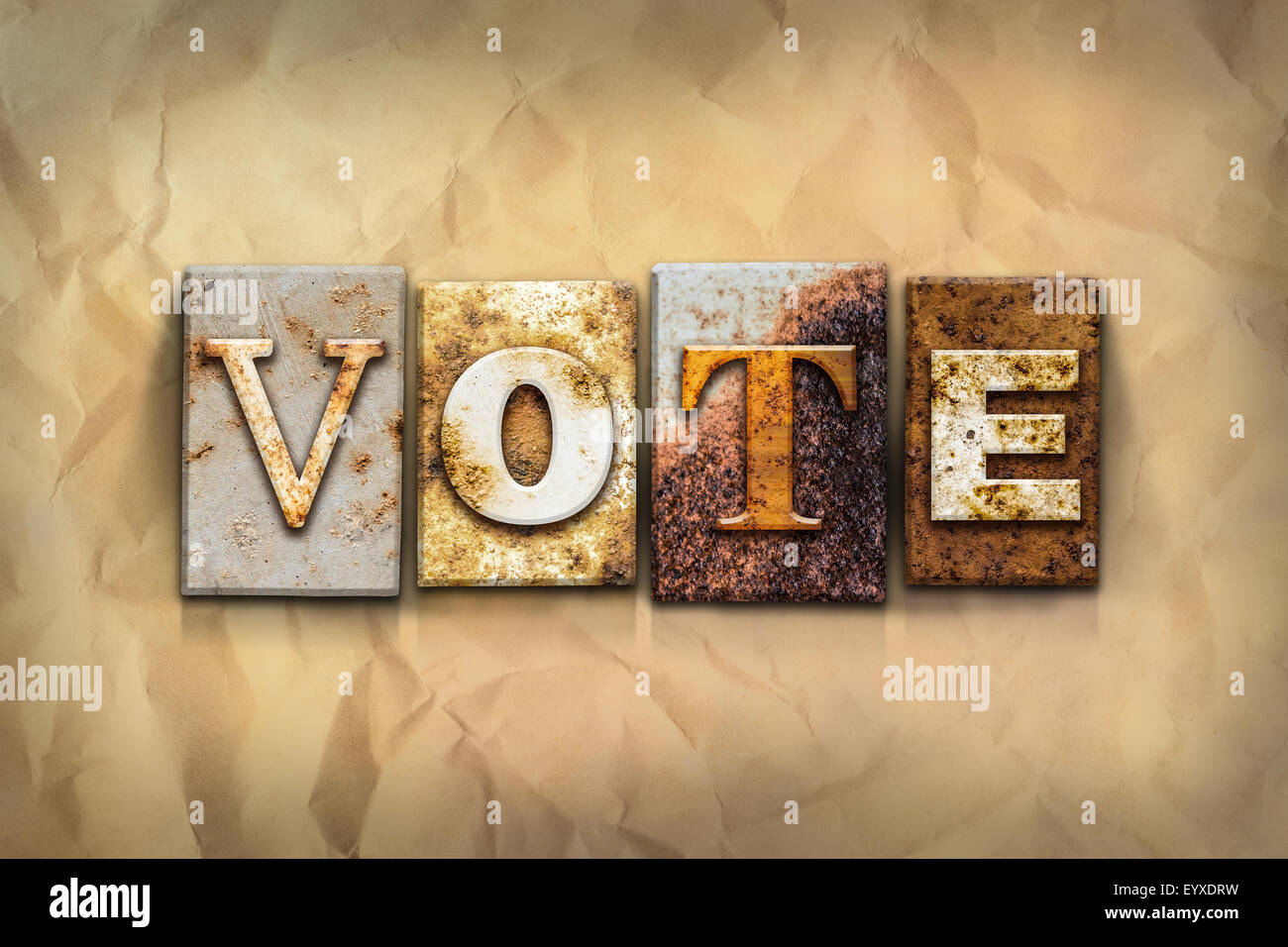 The word "VOTE" written in rusty metal letterpress type on a crumbled ...