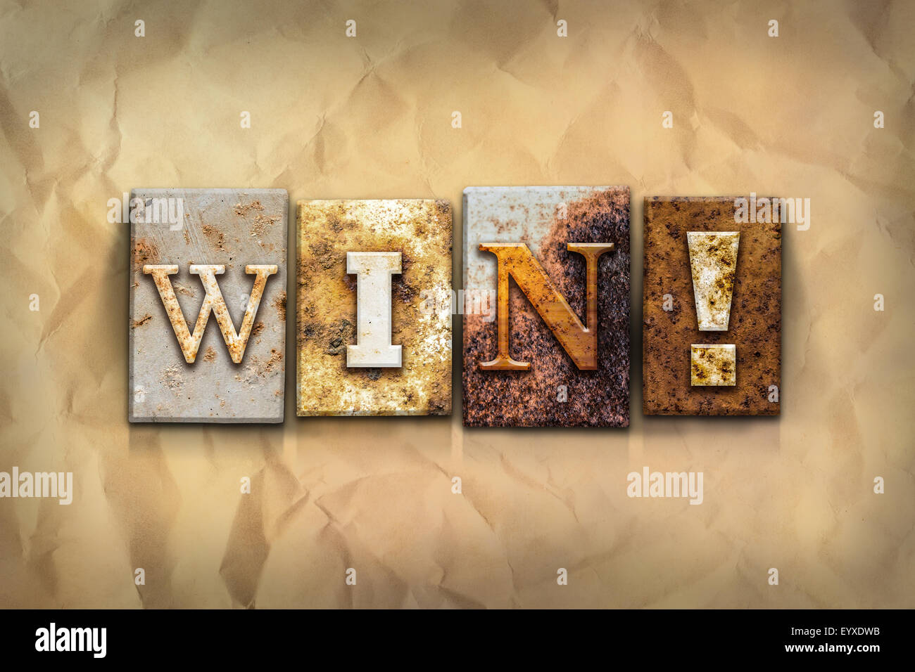 The word "WIN!" written in rusty metal letterpress type on a crumbled ...