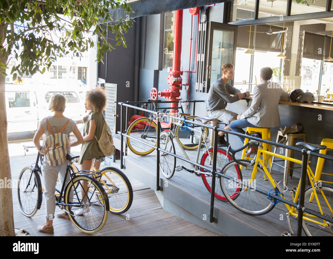 People with bicycles at urban outdoor cafe Stock Photo - Alamy