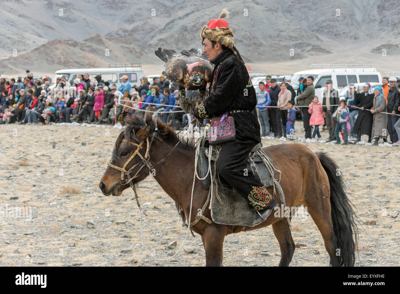 Kazakh eagle hunger with his eagle in front of the crowds, Eagle ...