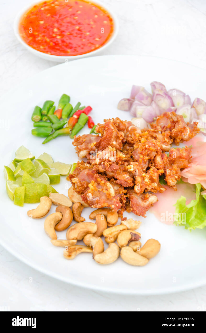 Deep fried sour fermented chicken knees tendon served with vegetables ...