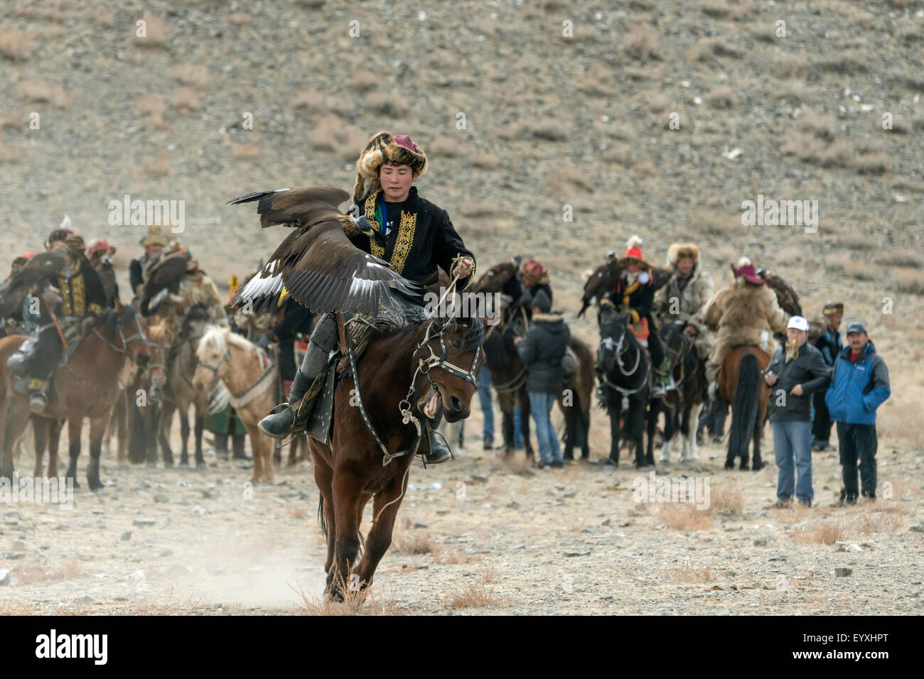 Young eagle hunter riding before the judges, Eagle Festival, Olgii ...